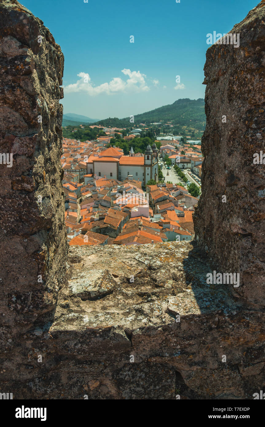 Old house roofs and cathedral seen by crenel at the castle in Castelo ...