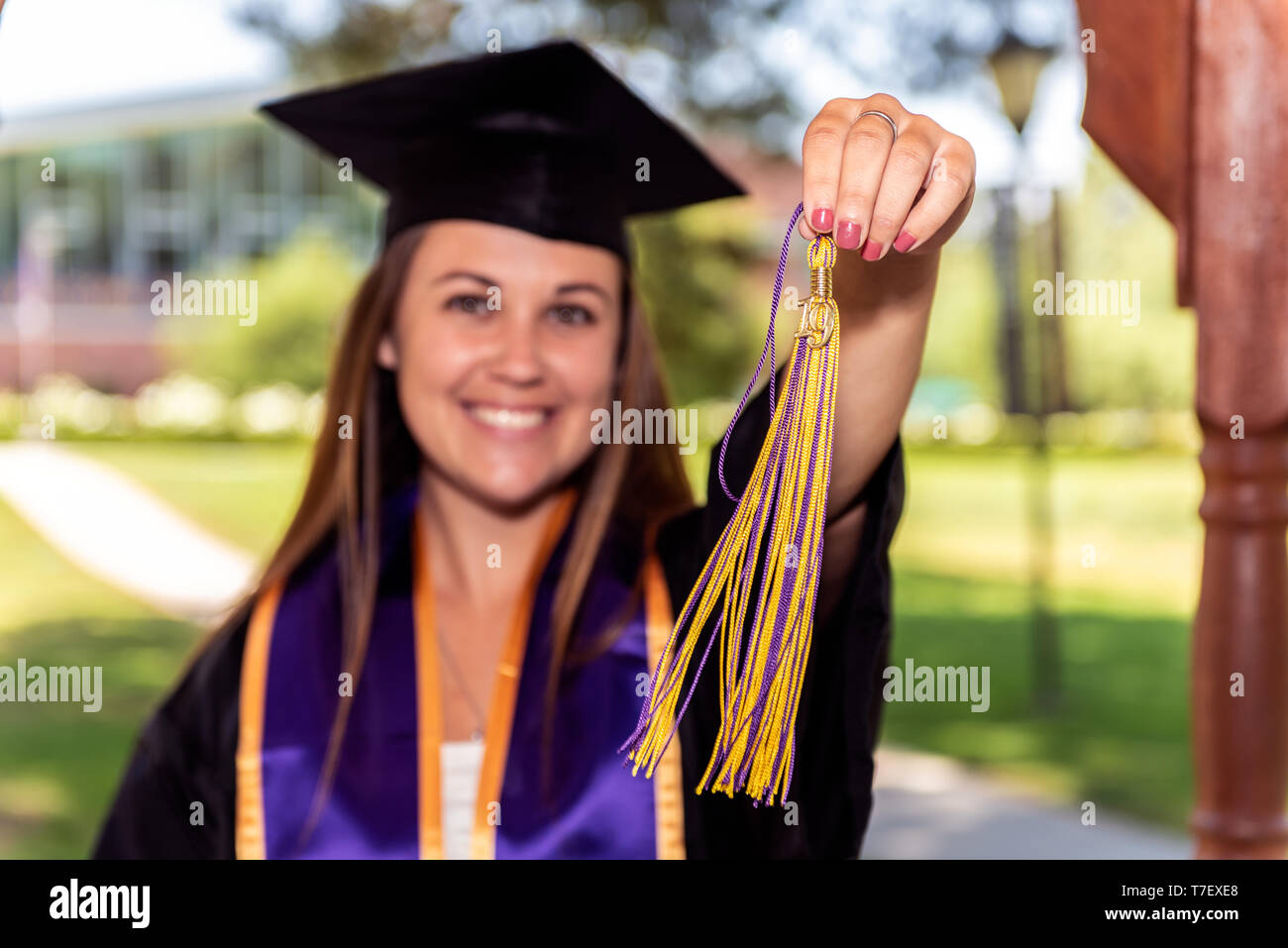 Beautiful young female student smile while holding class of 2019 tassel ...