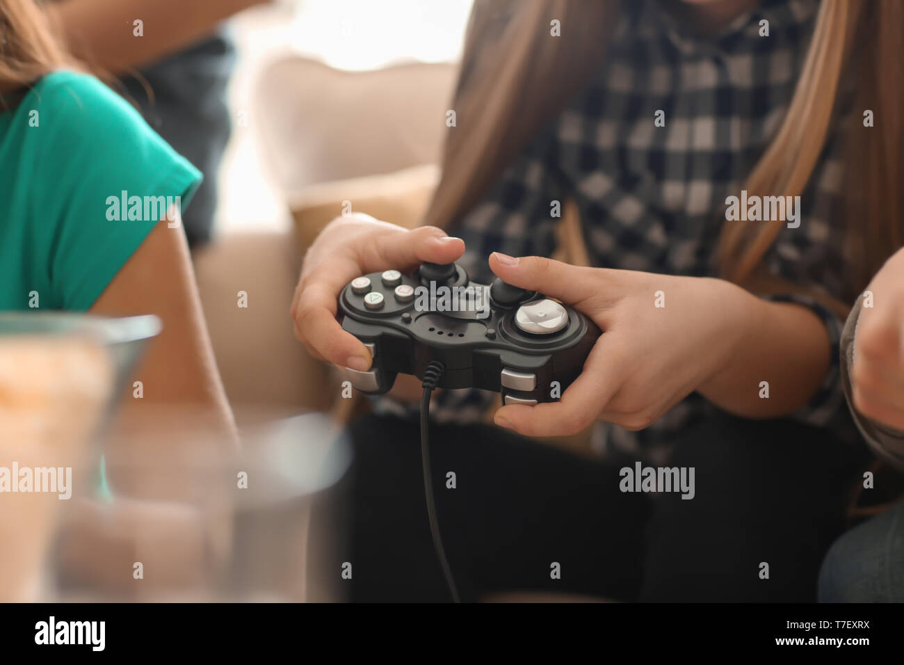 Girl playing video games at home, closeup Stock Photo - Alamy