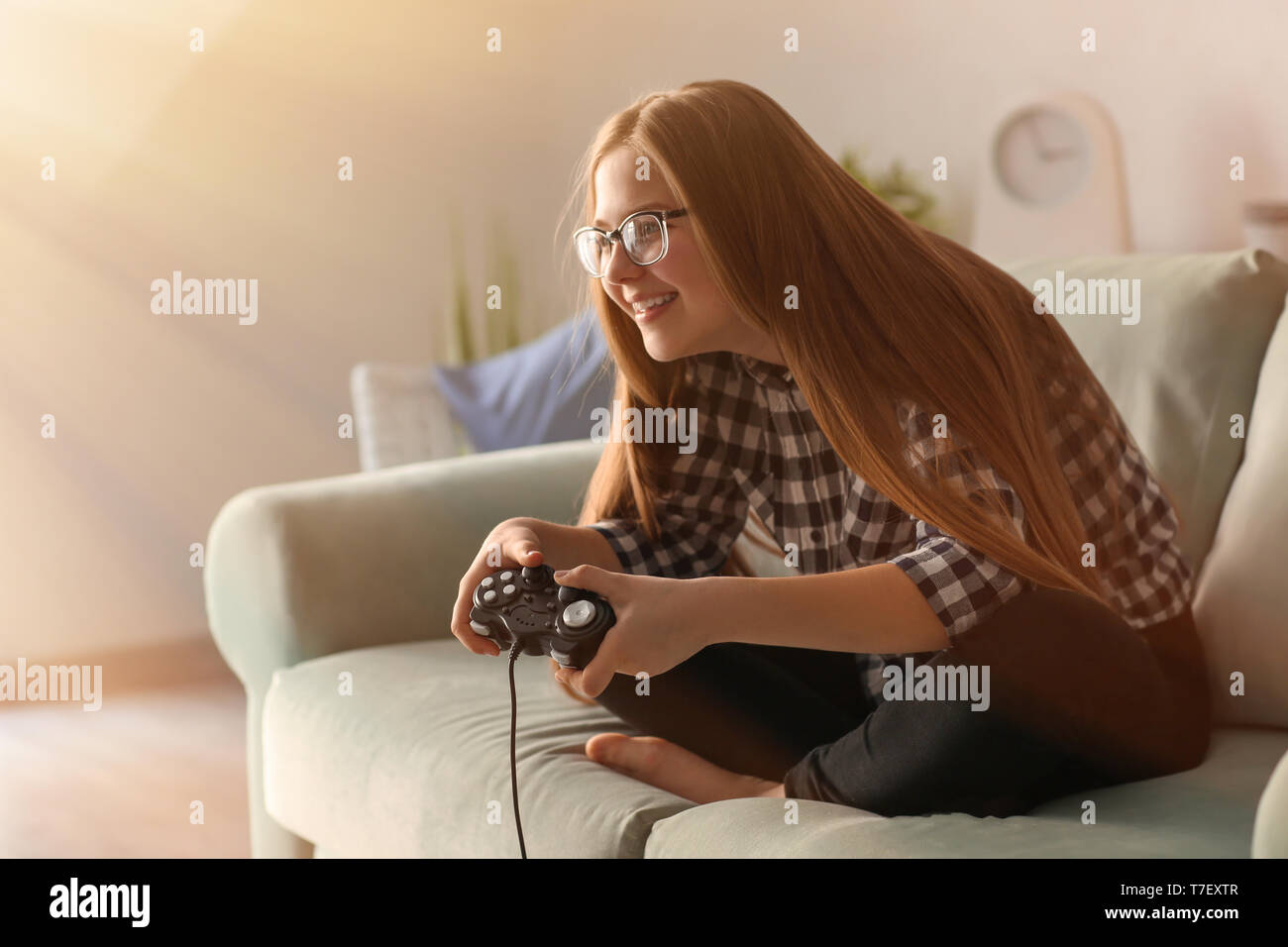 Cute girl playing video games at home Stock Photo - Alamy