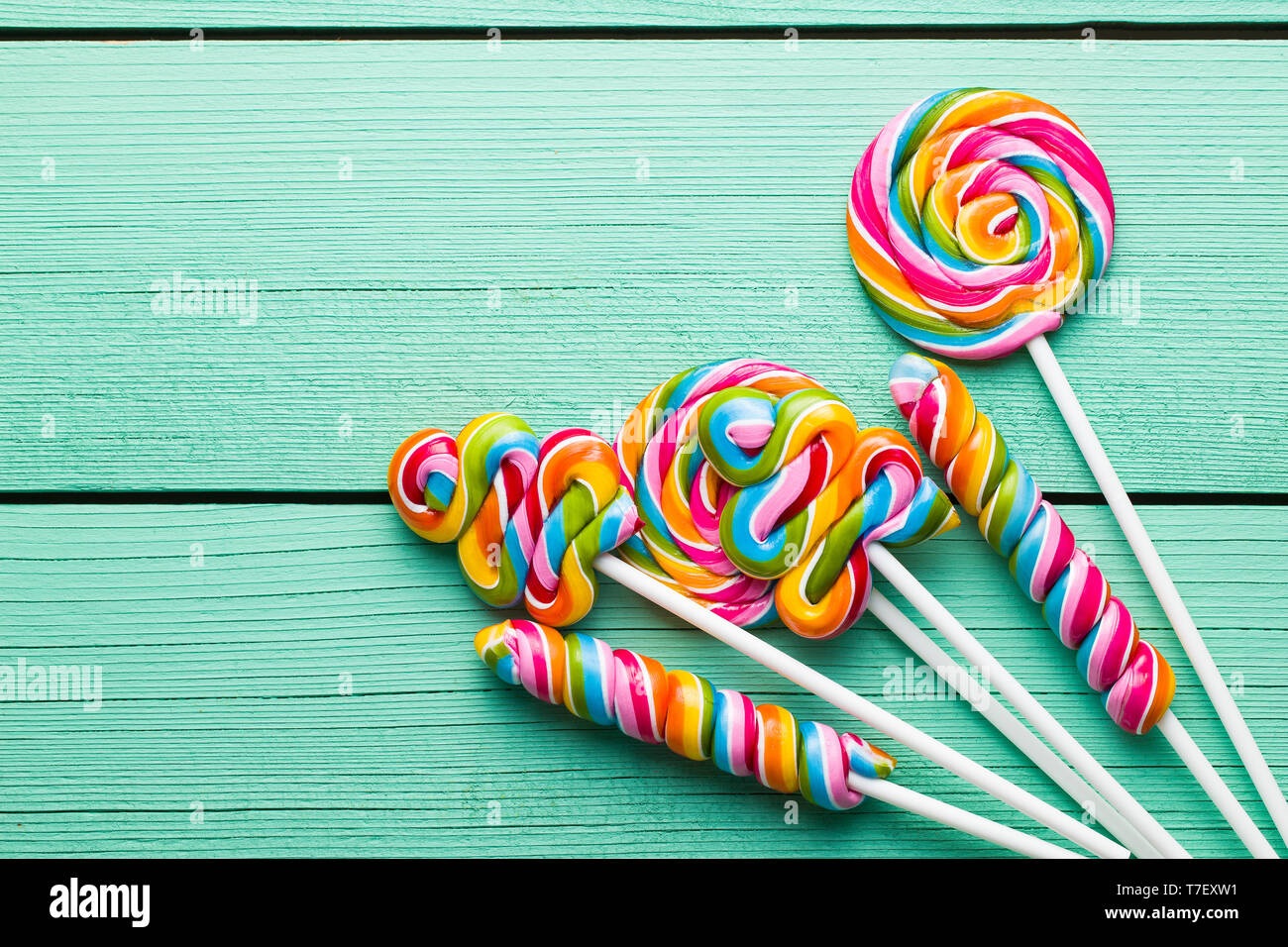 Various colorful lollipops on colorful wooden table Stock Photo - Alamy