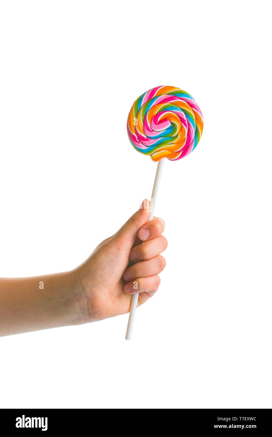 Swirl colorful lollipop in child hand isolated on white background ...