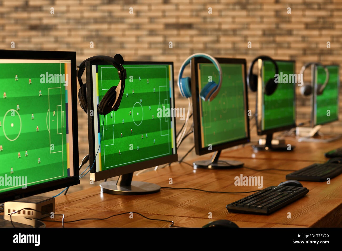 Table with computers for video games tournament Stock Photo - Alamy