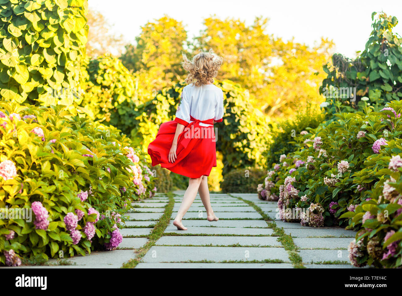 Full length back view of happy careless barefoot attractive young ...