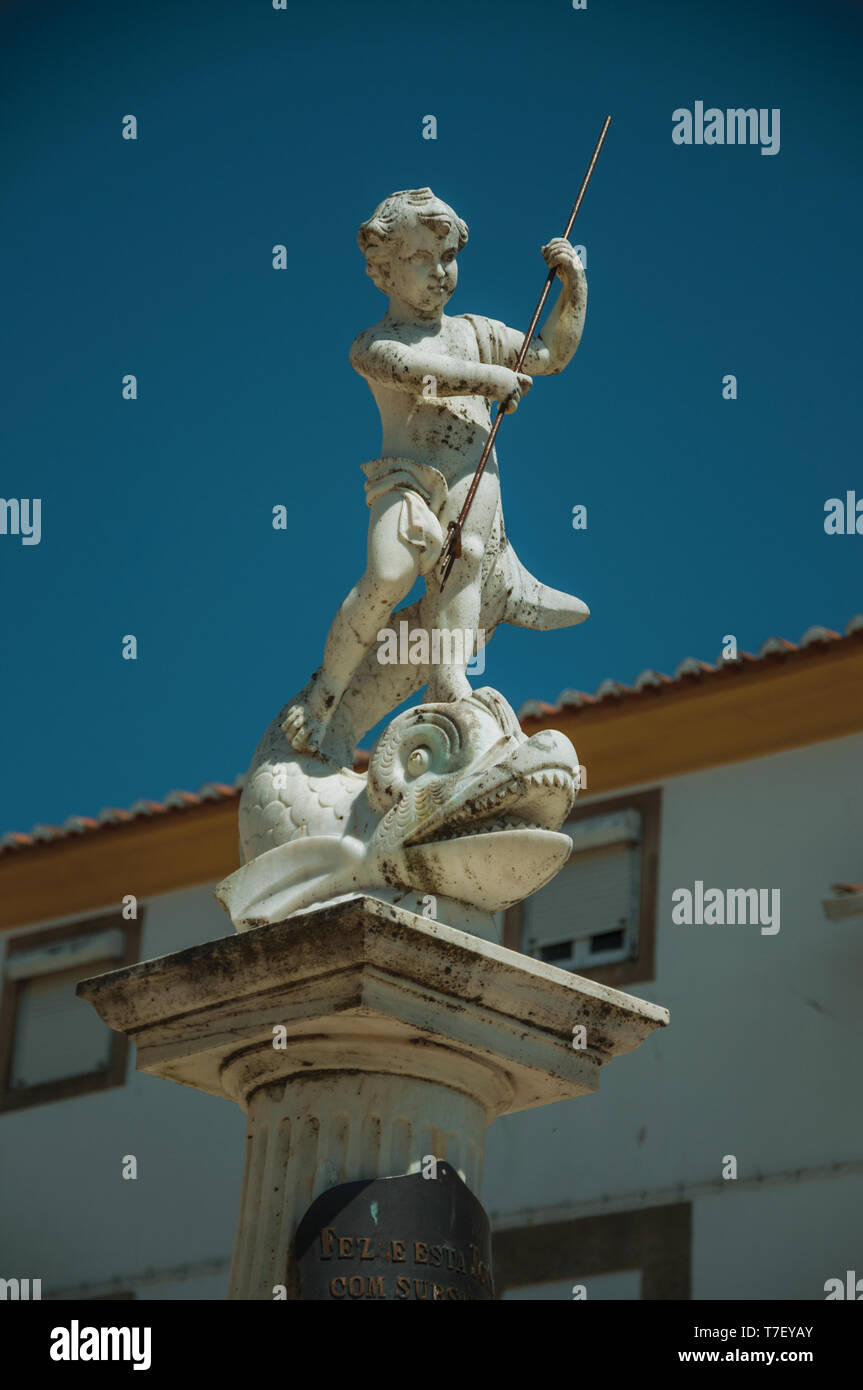 Curious marble statue on top of pillar in a sunny day at Castelo de ...