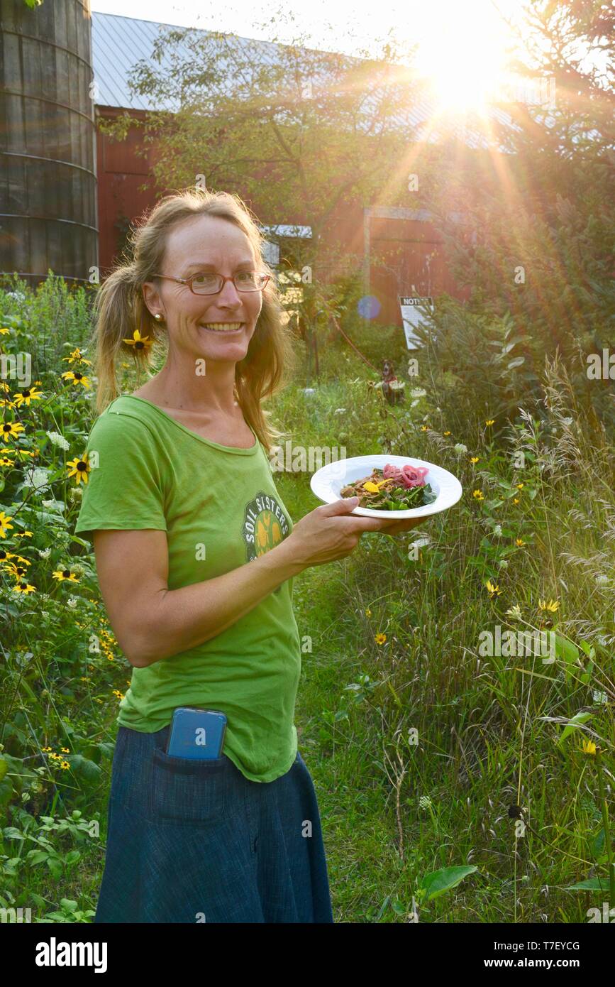 Woman farmer catering chef on her working pig farm, with a prepared ...