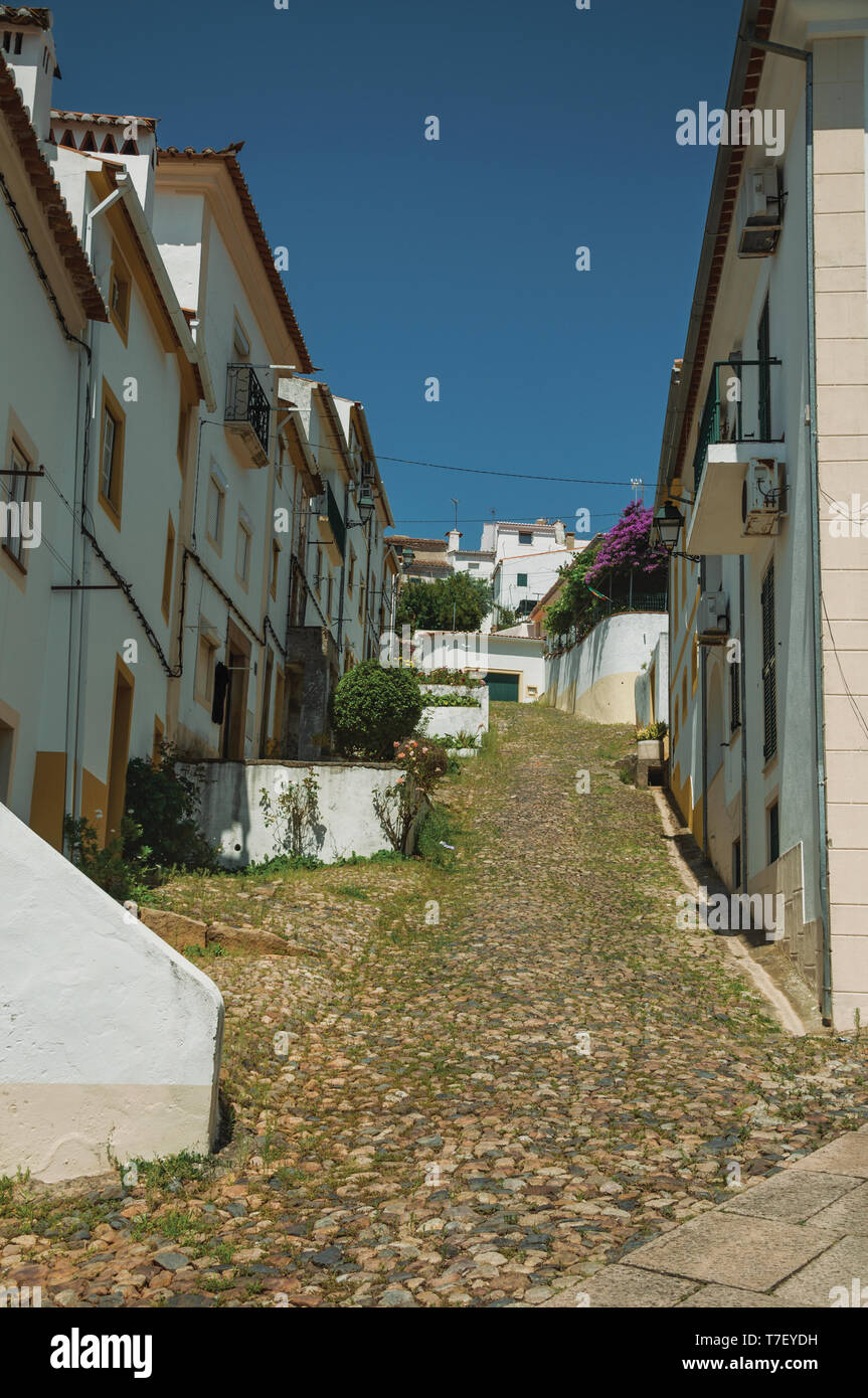 Facade of old colorful terraced houses in deserted alley on slope at ...