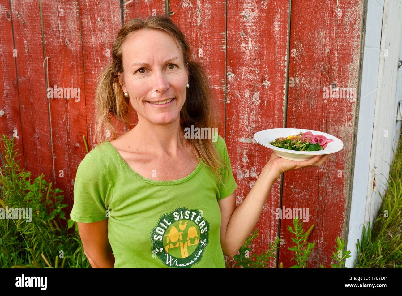 Woman farmer catering chef on her working pig farm, with a prepared ...