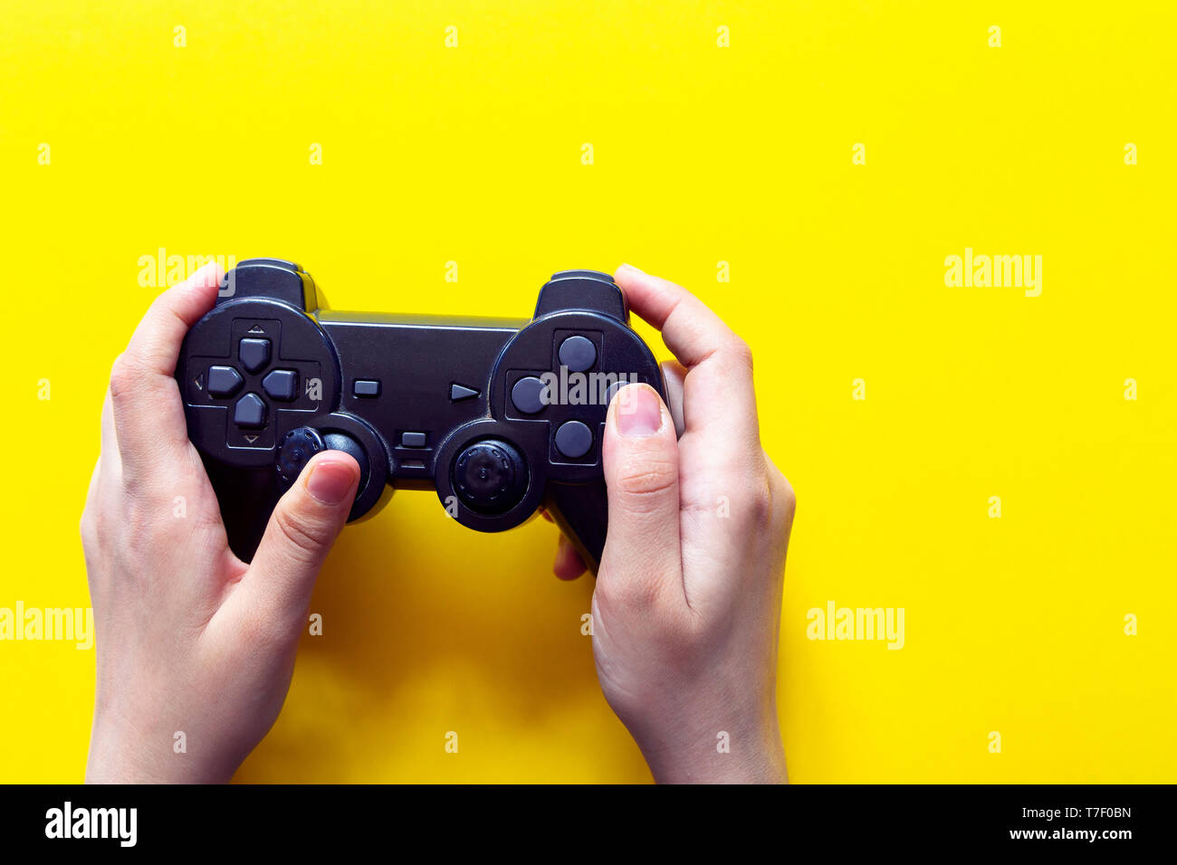 Vertical view of hands with gamepad. Gaming concept. Retro styled ...