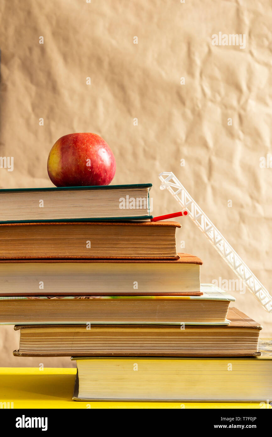 Back to school concept. Stack of books and apple Stock Photo - Alamy