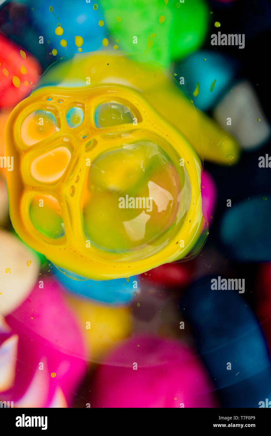 Colorful paint bubbles on a glass backround Stock Photo - Alamy