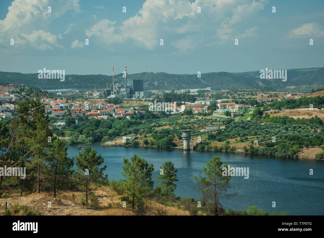 Tejo River valley with hills covered by undergrowth and industry on ...