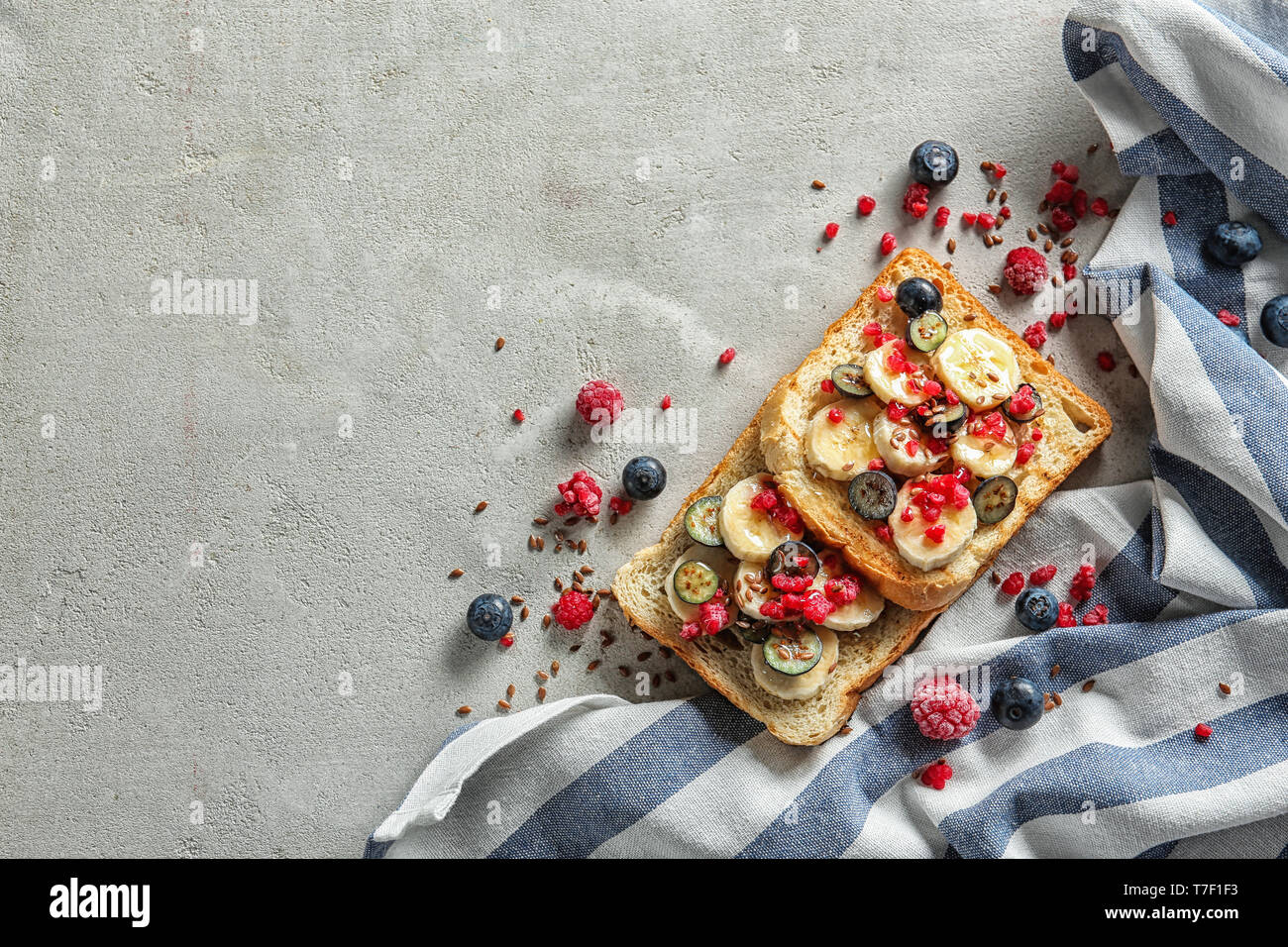 Tasty sweet toasts with fresh banana and berries on table Stock Photo ...