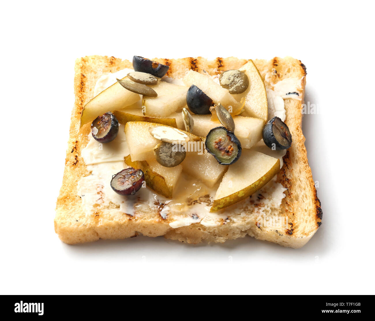 Tasty sweet toast with fresh sliced pear, seeds and berries on white ...