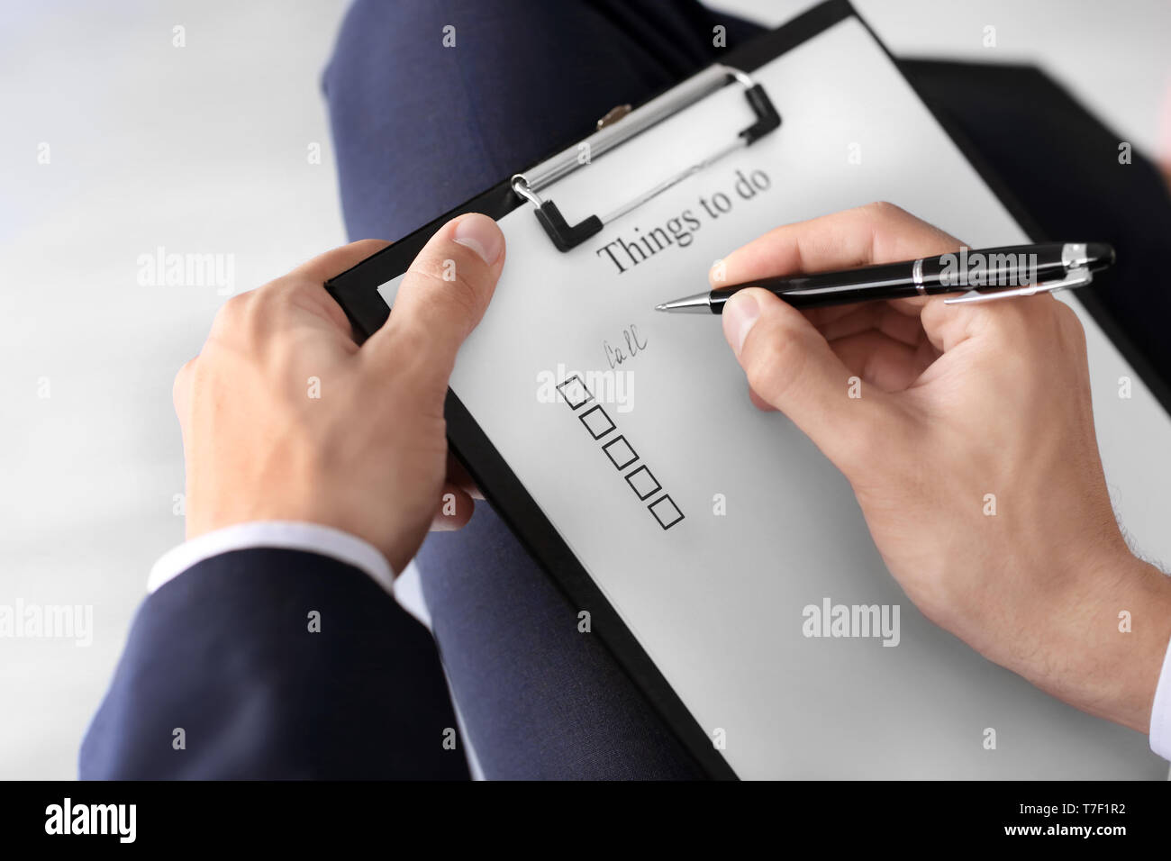 Businessman with to-do list in office, closeup Stock Photo - Alamy