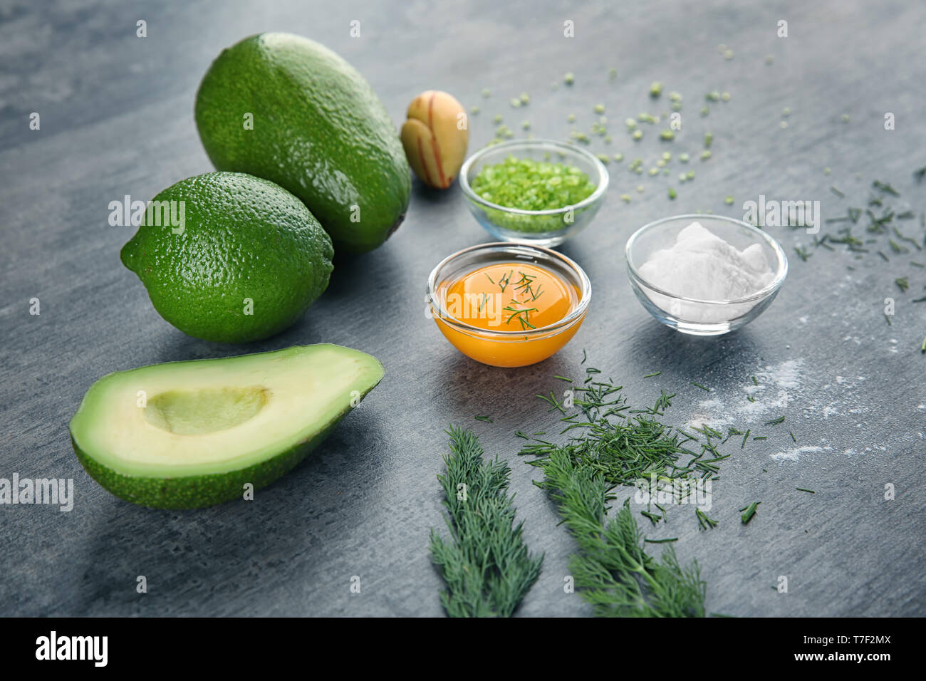 Natural ingredients for homemade avocado scrub on grey background Stock ...