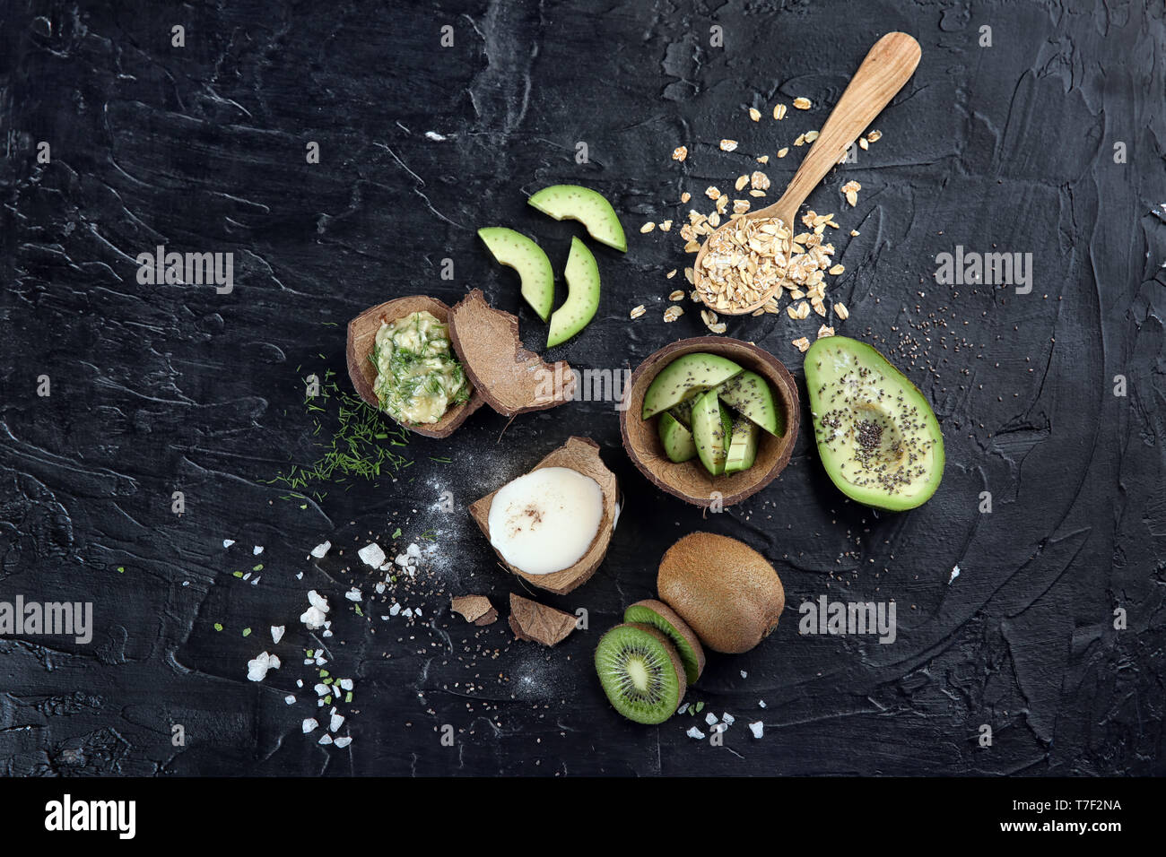 Natural ingredients for homemade cosmetics on black textured background ...