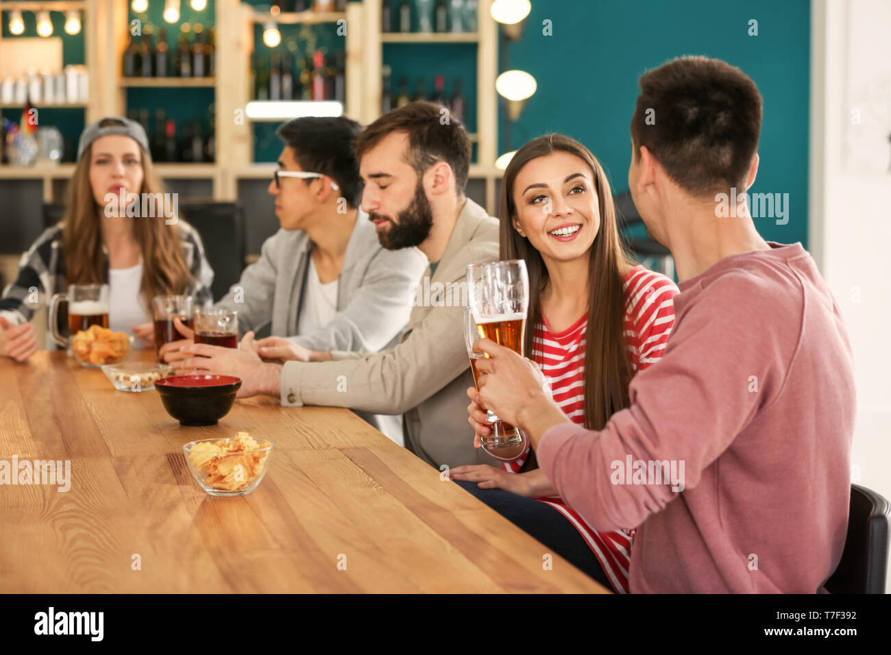 Group of friends drinking beer in bar Stock Photo - Alamy
