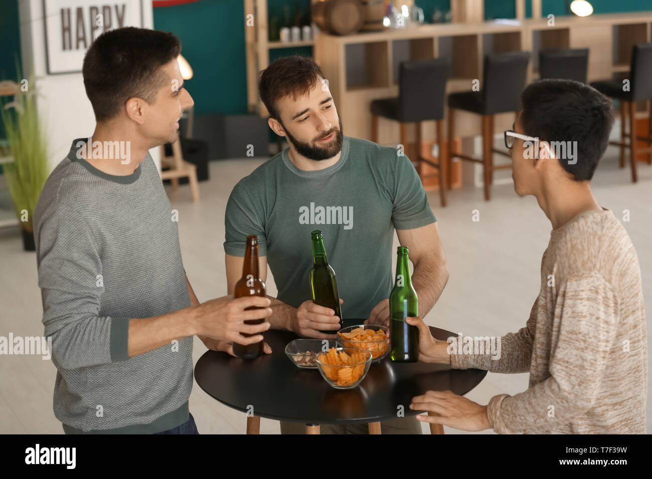 Men drinking beer in bar Stock Photo - Alamy