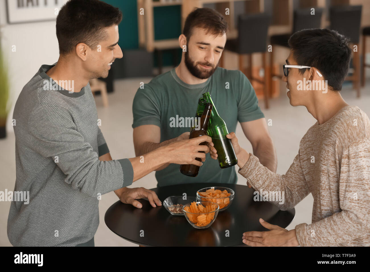 Men drinking beer in bar Stock Photo - Alamy