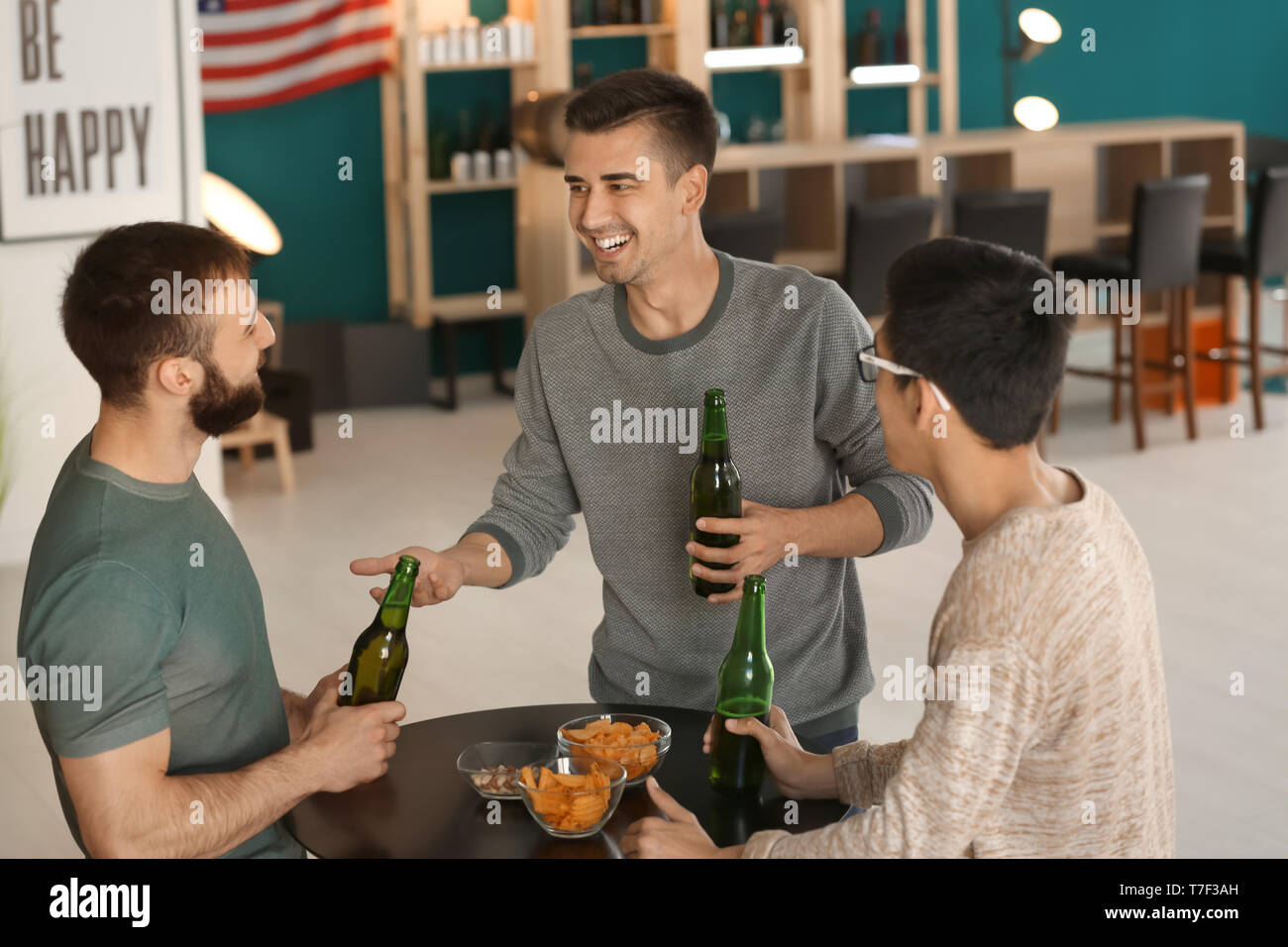 Men drinking beer in bar Stock Photo - Alamy