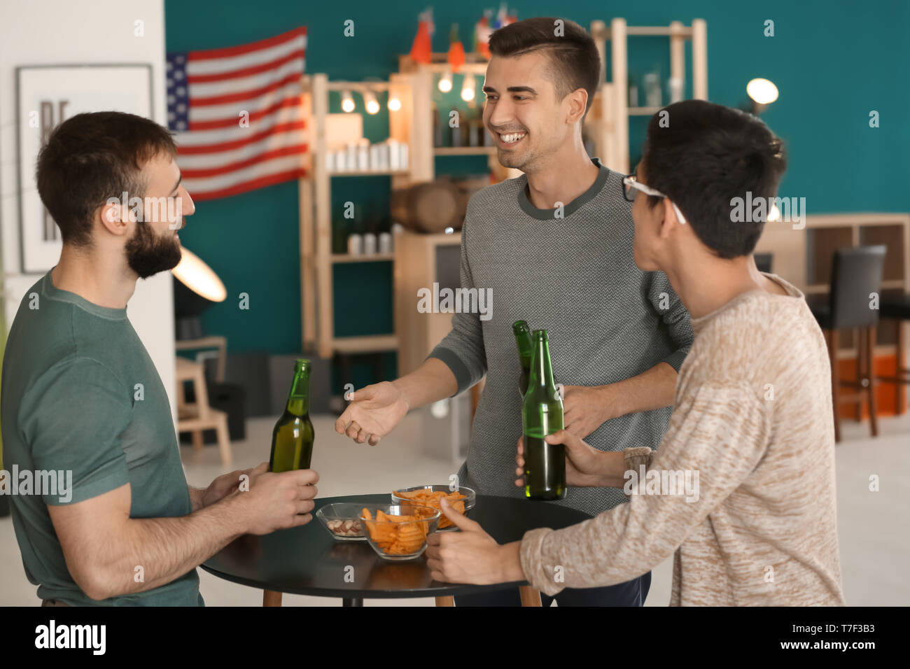 Men drinking beer in bar Stock Photo - Alamy