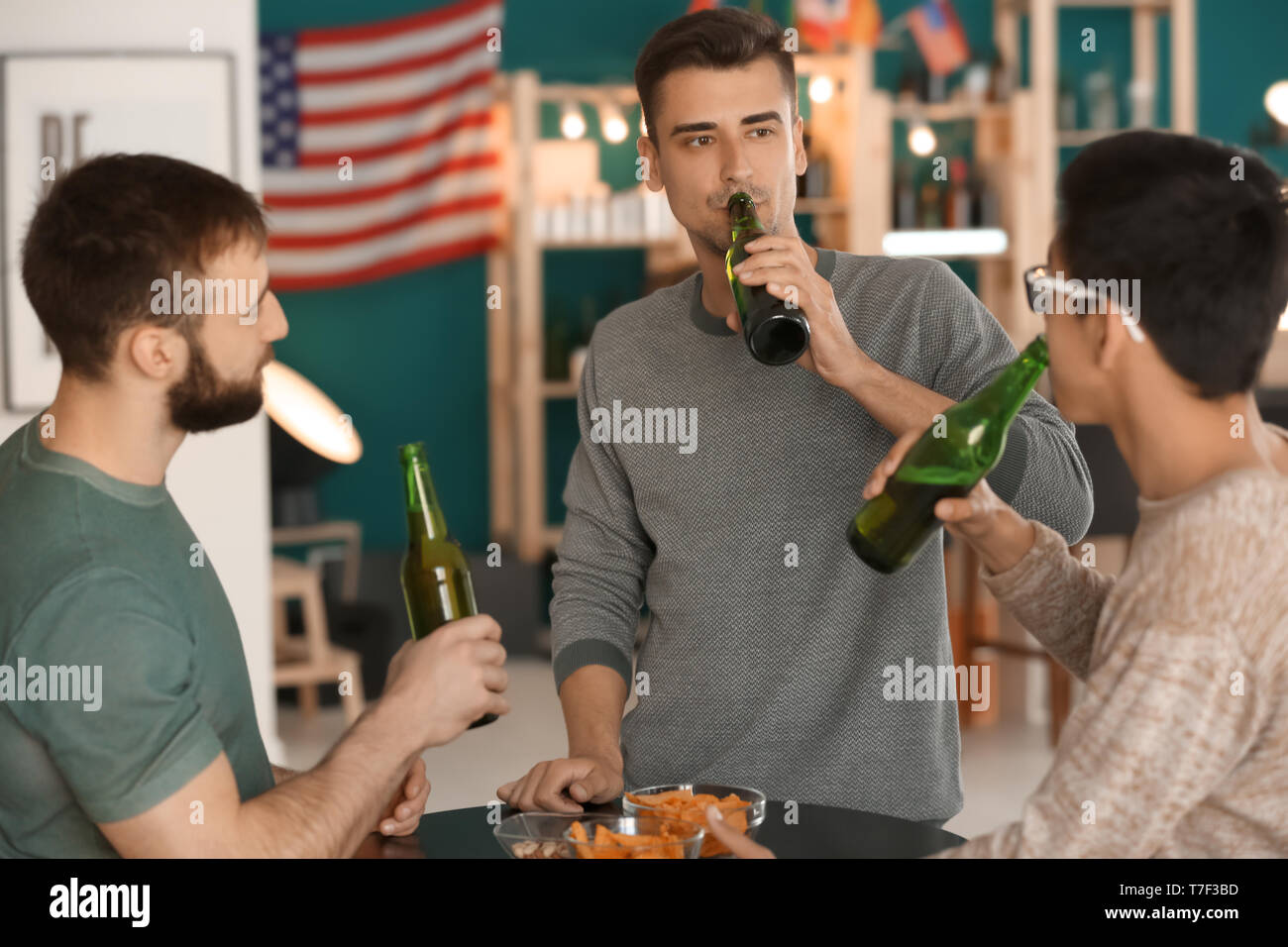 Men drinking beer in bar Stock Photo - Alamy