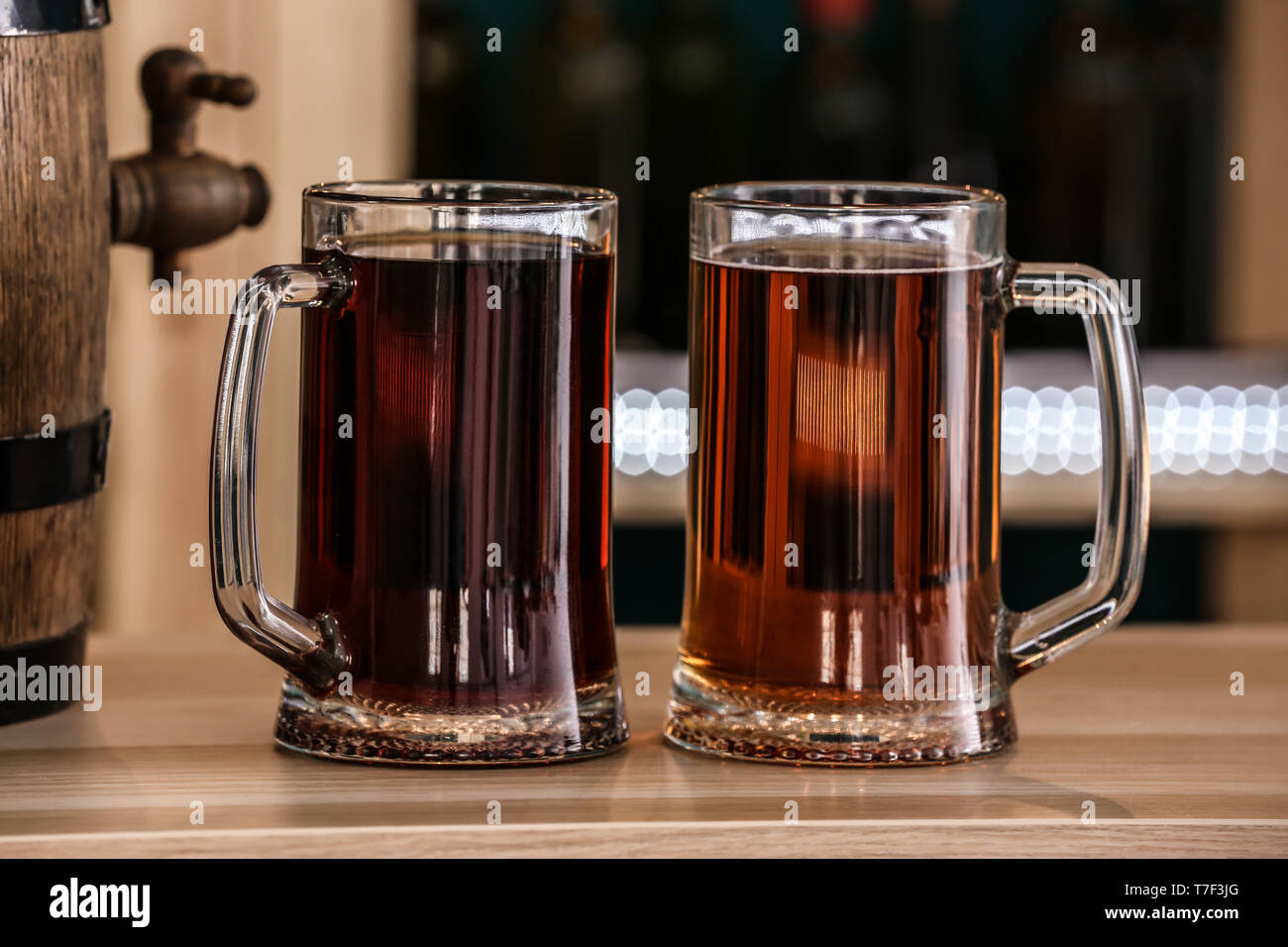 Glasses of beer on table in bar Stock Photo - Alamy