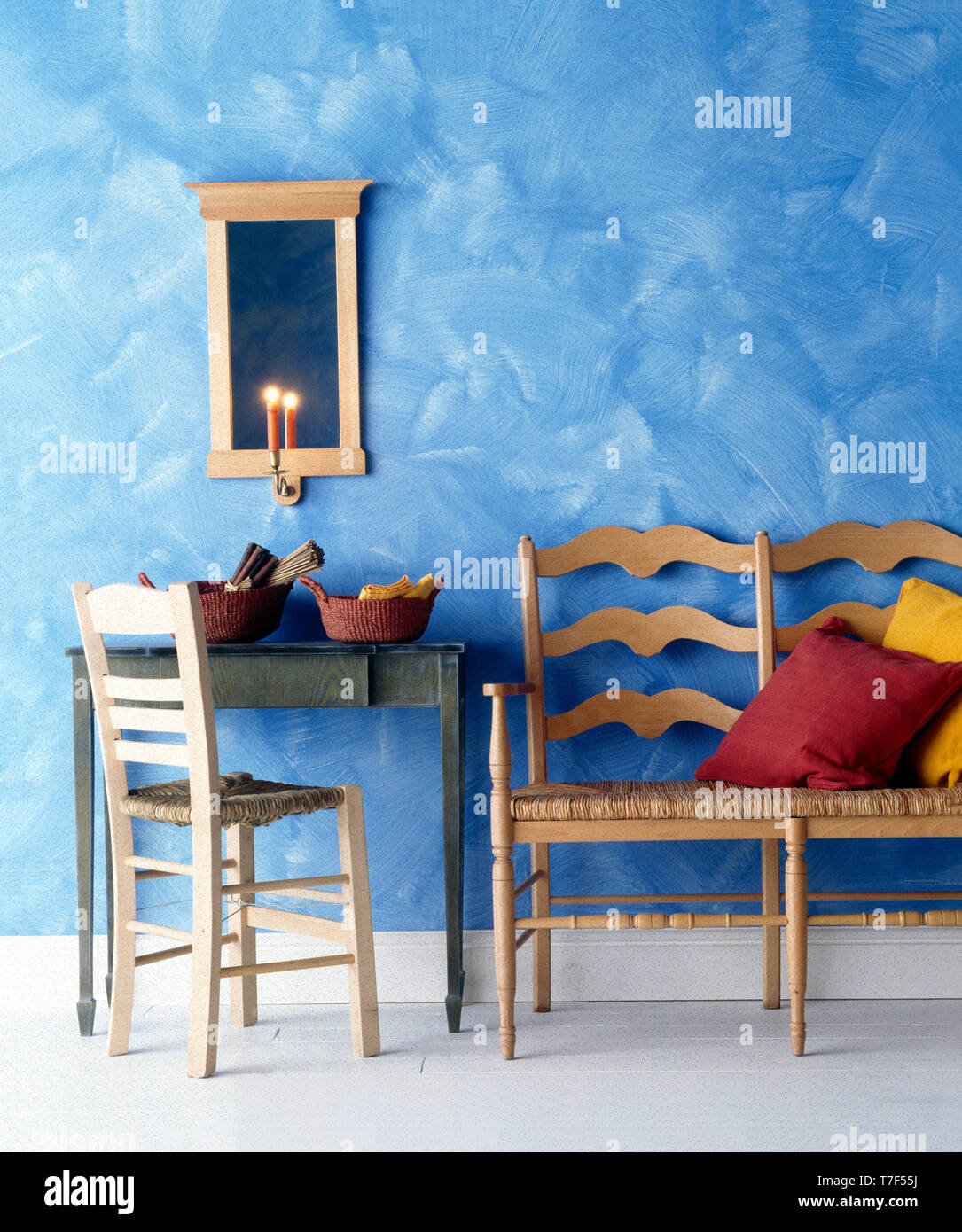 Settle and chair in blue room with ragging paint effect on wall Stock ...