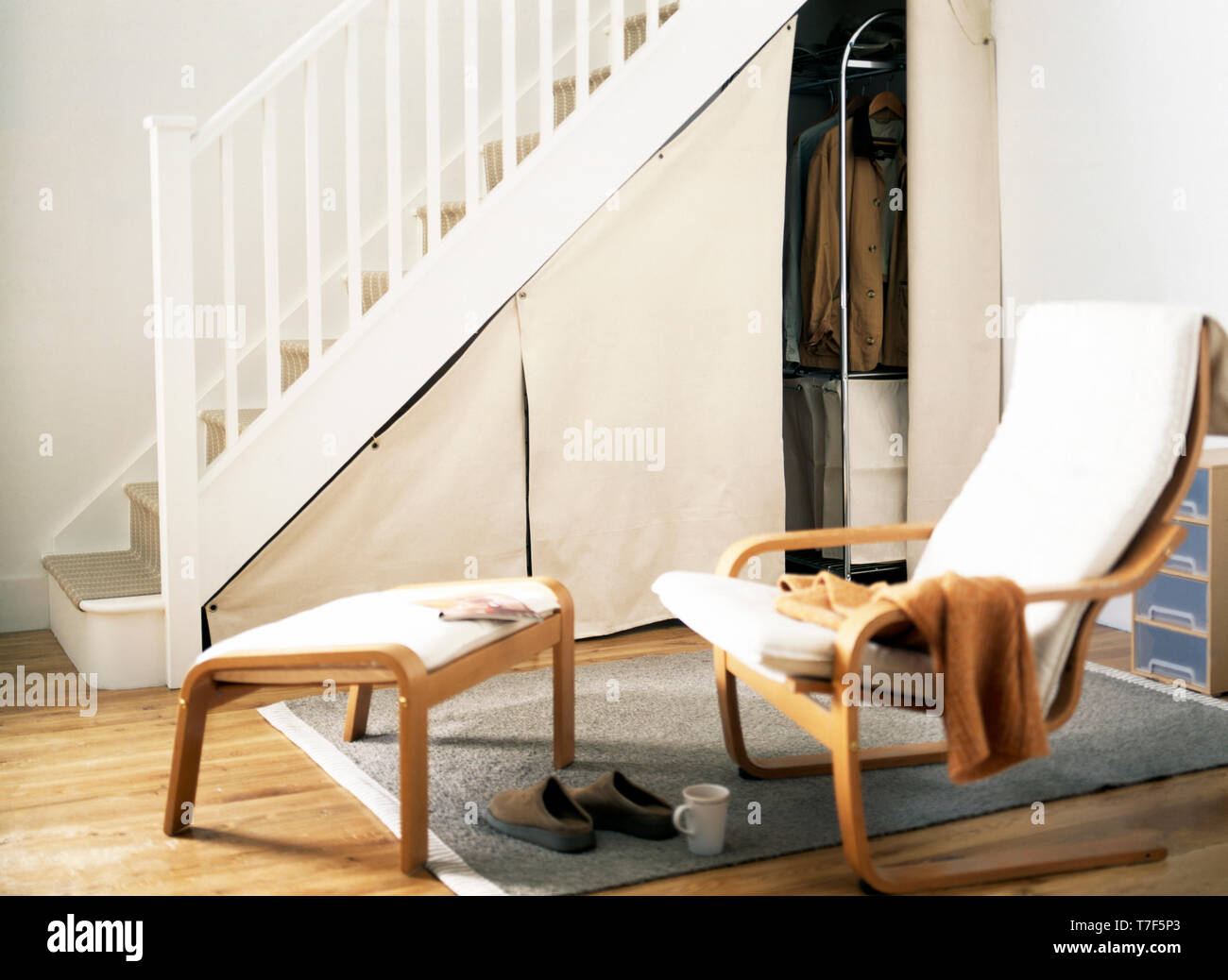 Scandinavian style chair and stool in hall living space Stock Photo - Alamy
