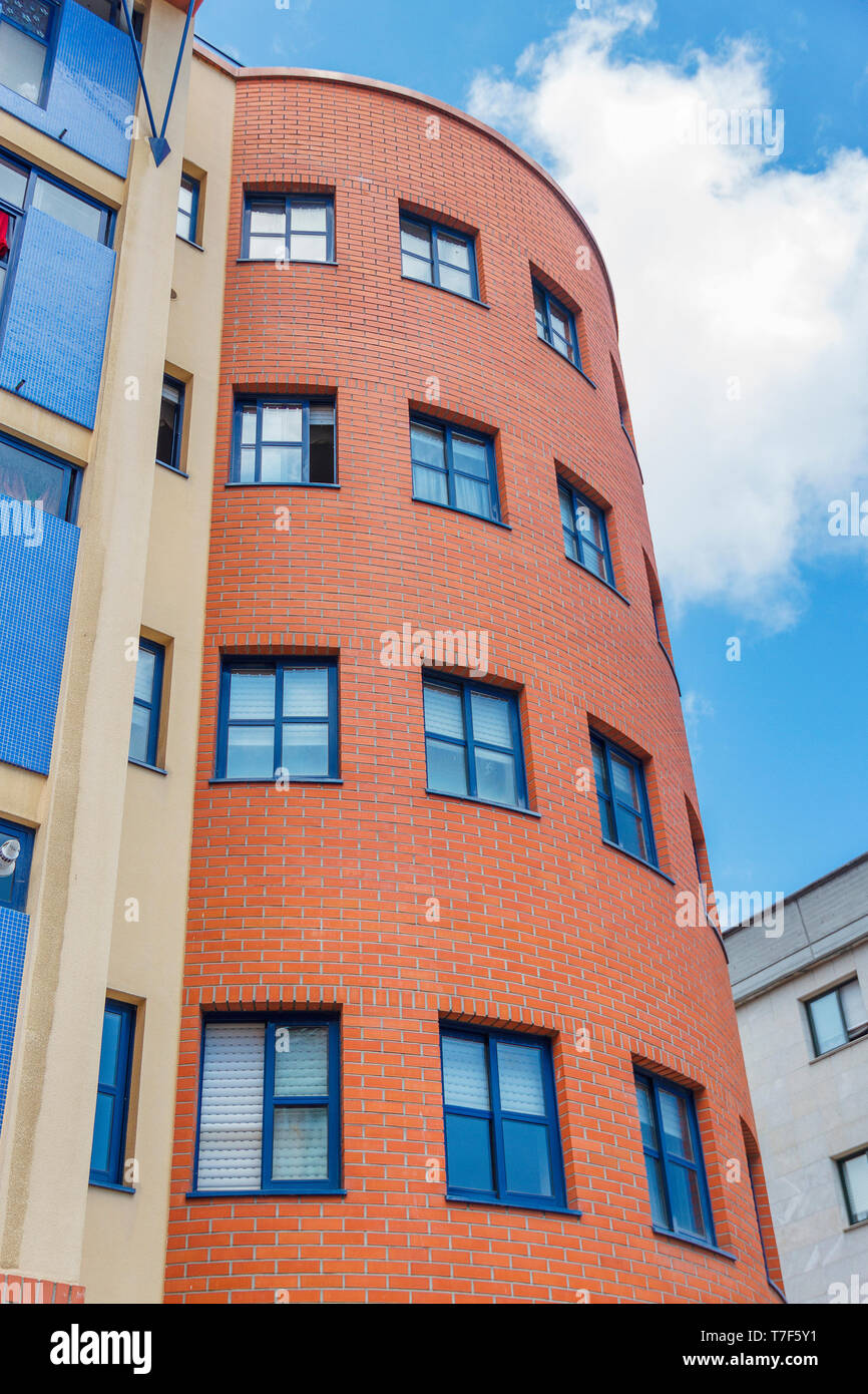 Cylindrical brick building with blue windows in O Burgo city Stock ...