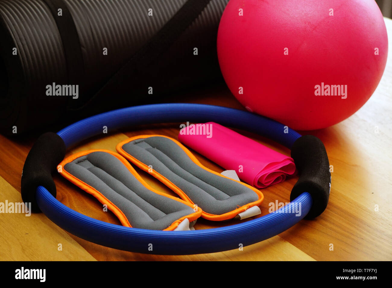 Pilates set with mat stretch ball on wooden background Stock Photo - Alamy