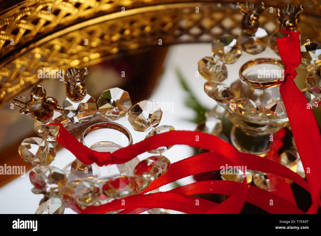 Engagement rings on mirror background with red ribbon Stock Photo - Alamy