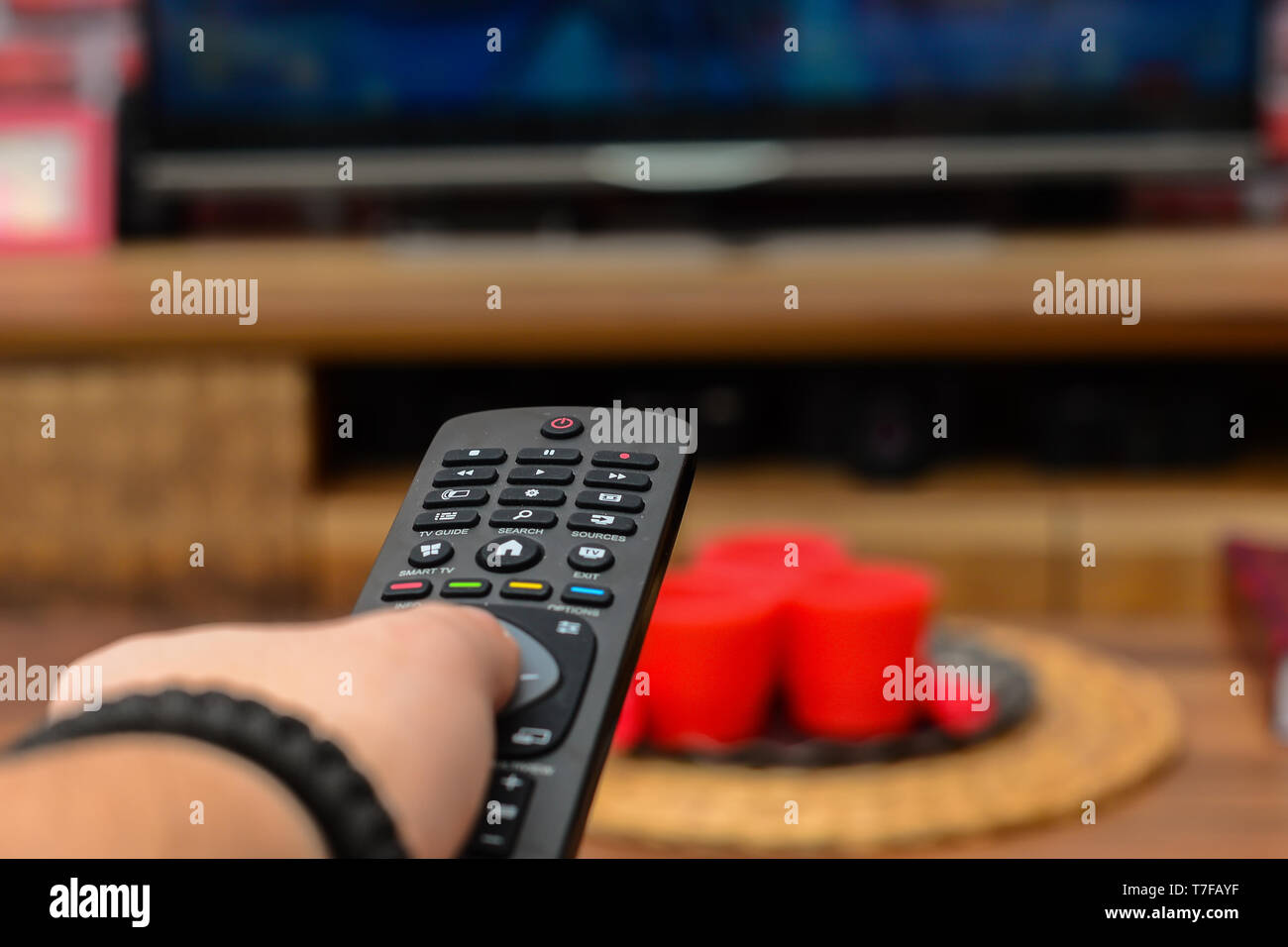 Person pointing remote at tv hi-res stock photography and images - Alamy