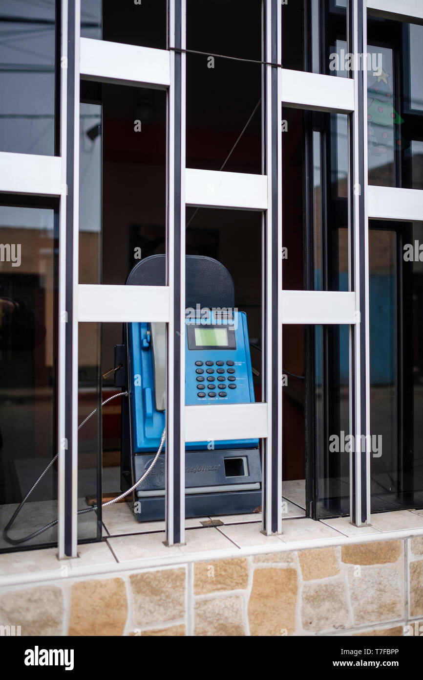 Coin telephone for public use located on a private house window in ...