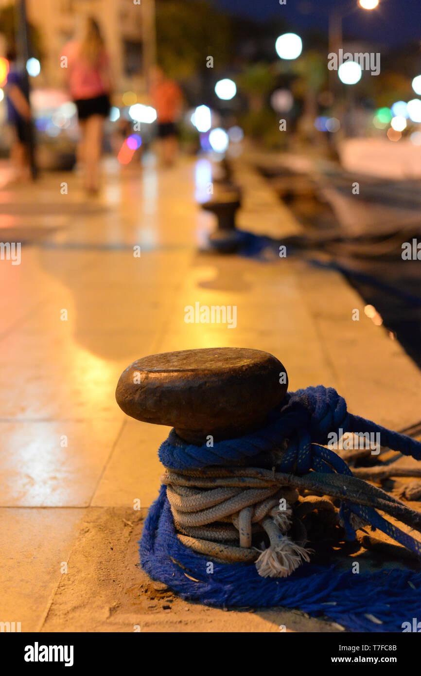 Iron bollard on the dock at night Stock Photo - Alamy