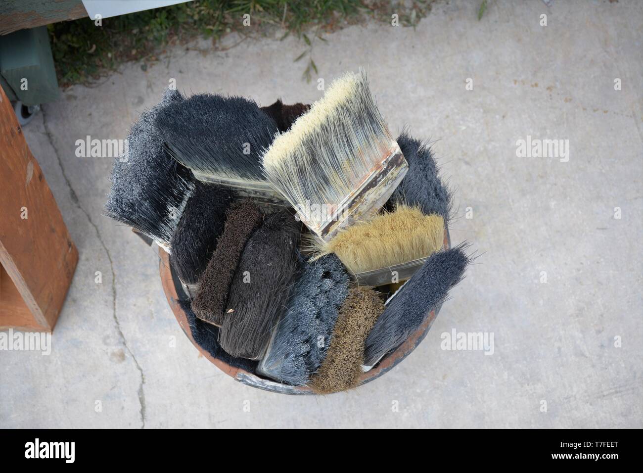 Bucket of old used paint brushes for a collection as a hobby Stock ...