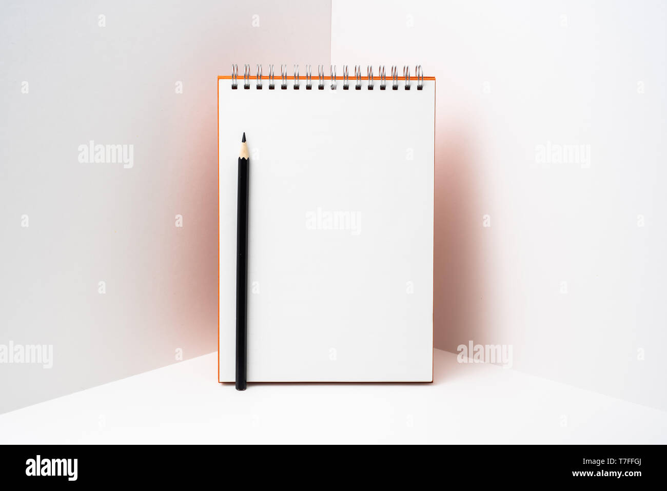 Design concept - perspective view of orange spiral notebook, white page ...