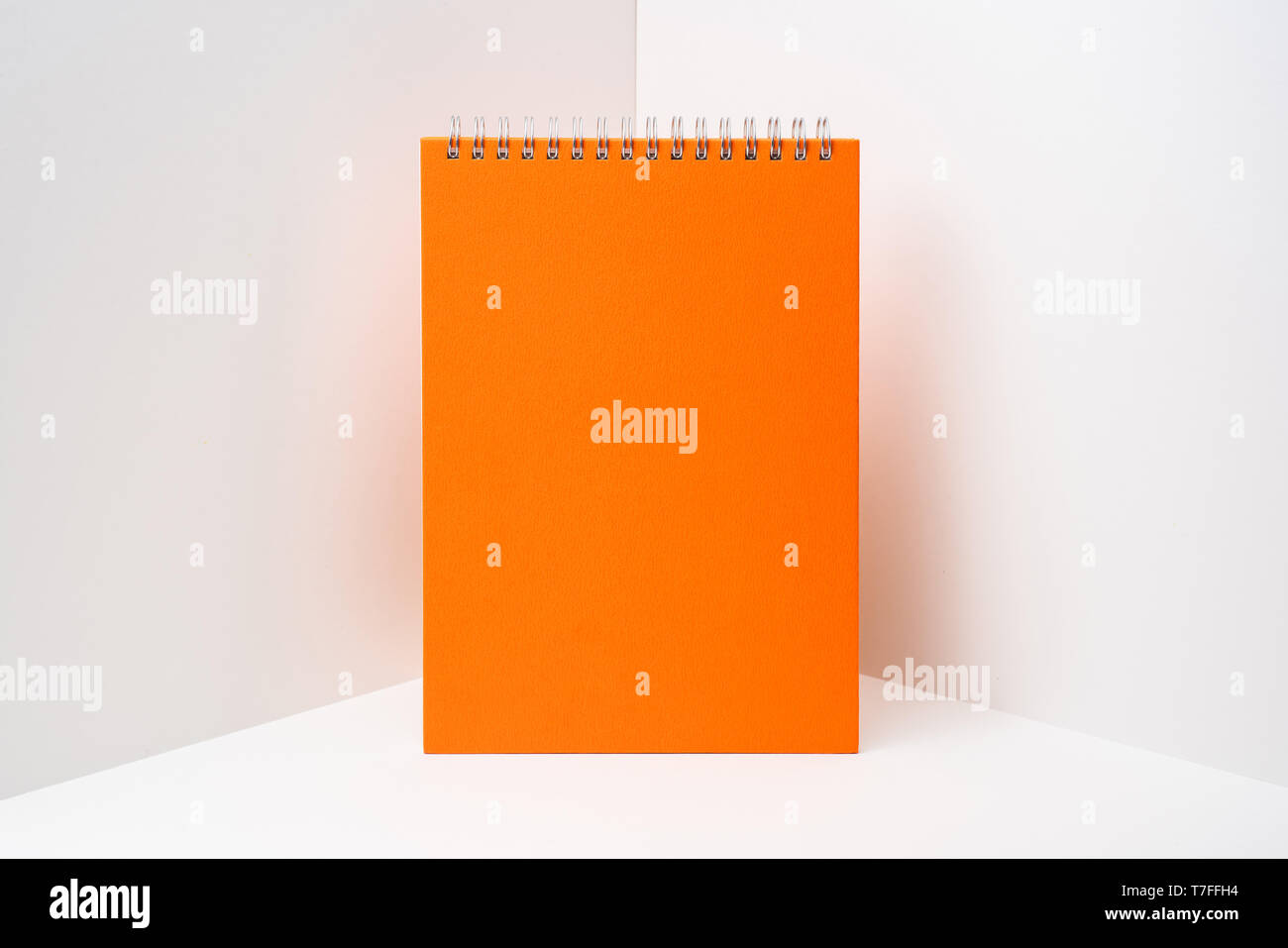Design concept - perspective view of orange spiral notebook, white page ...