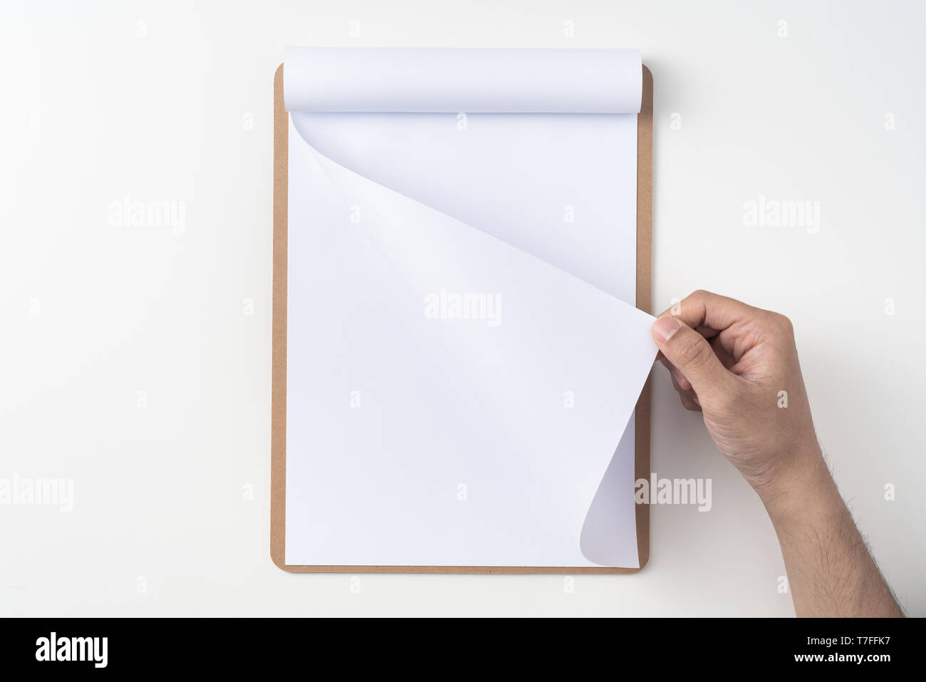 Design concept - top view of man hand hold white A4 flipped paper on ...