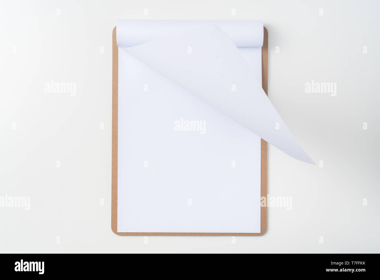 Design concept - top view of white A4 flipped paper on brown clipboard ...