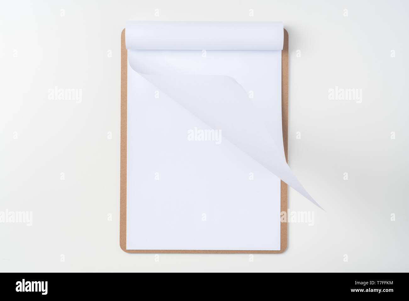 Design concept - top view of white A4 flipped paper on brown clipboard ...