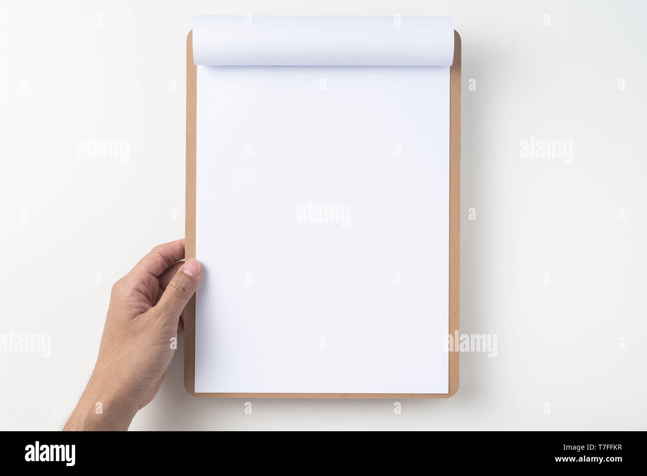 Design concept - top view of man hand hold white A4 flipped paper on ...