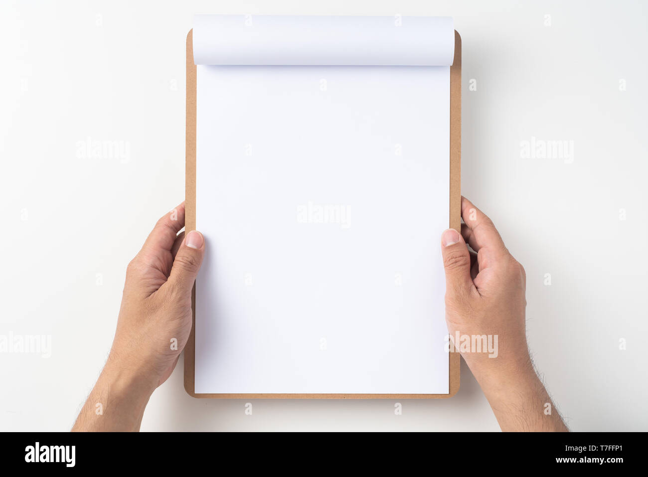 Design concept - top view of man hand hold white A4 flipped paper on ...