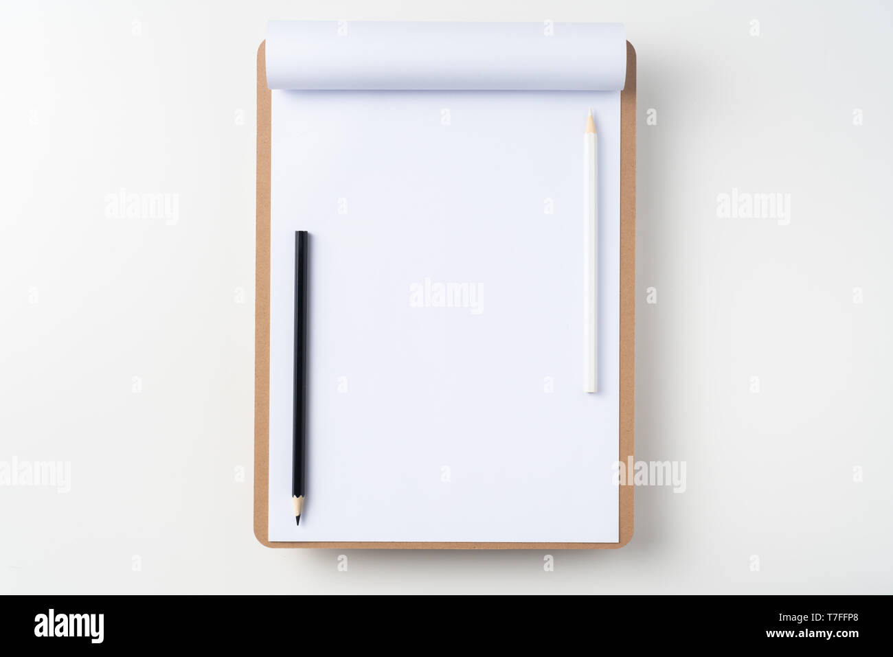 Design concept - top view of white A4 flipped paper on brown clipboard ...