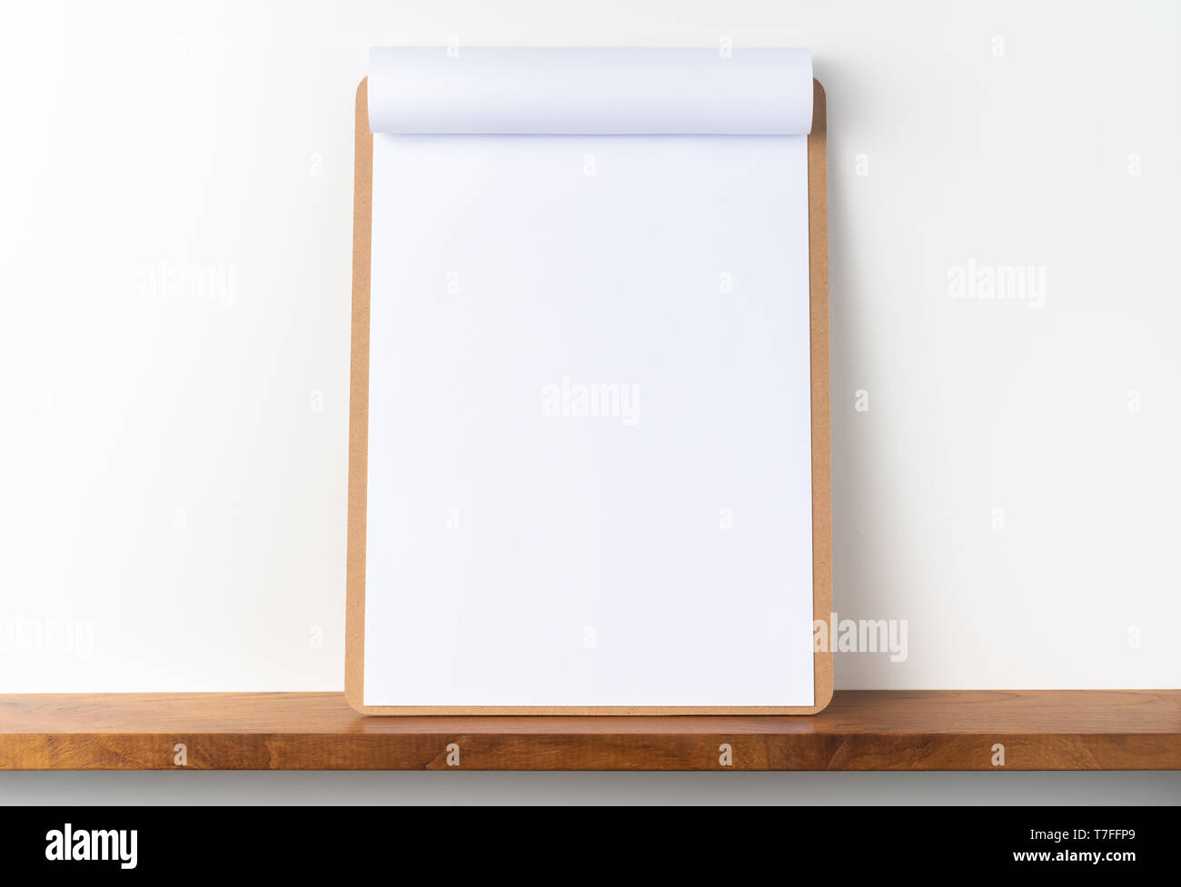 Design concept - top view of white A4 flipped paper on brown clipboard ...