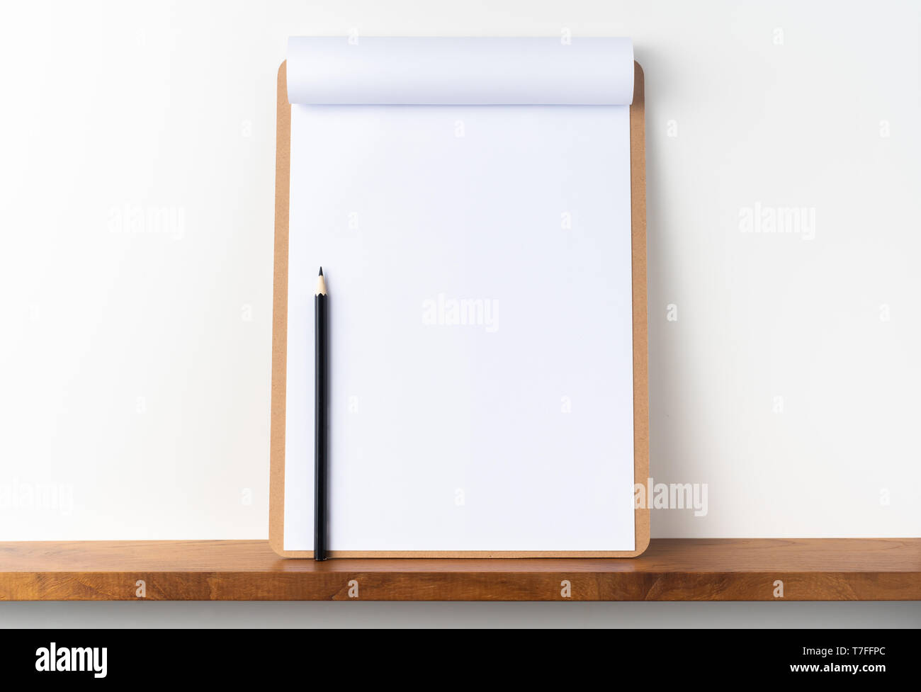 Design concept - top view of white A4 flipped paper on brown clipboard ...