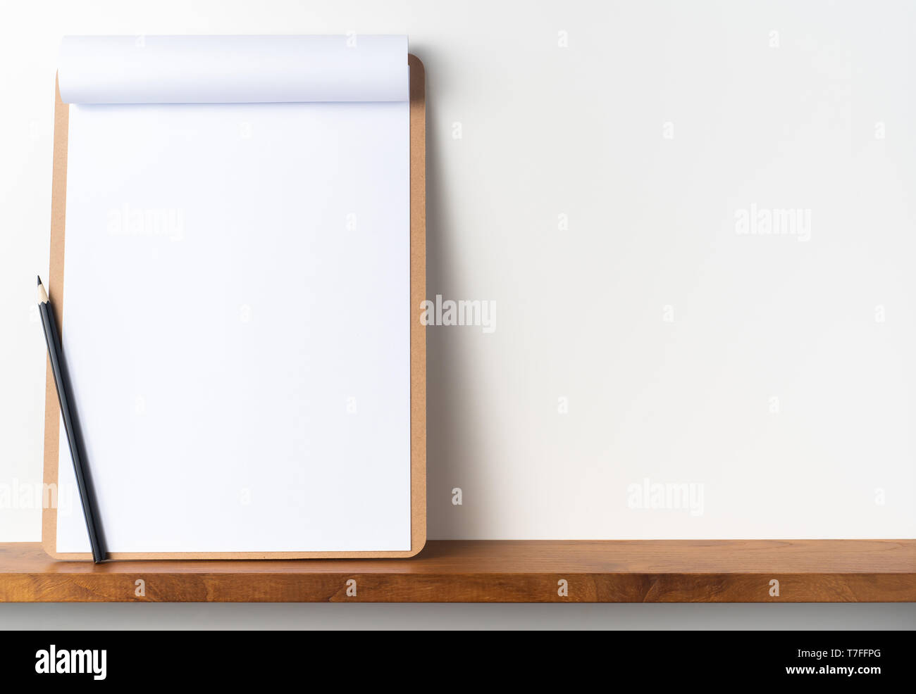 Design concept - top view of white A4 flipped paper on brown clipboard ...