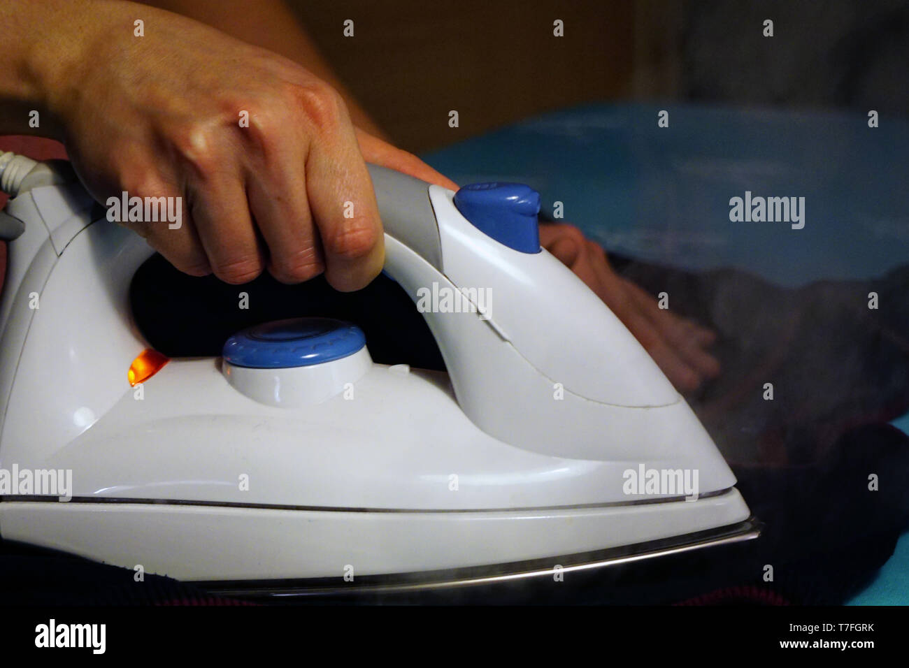 Household ironing at home hands on the iron Stock Photo - Alamy