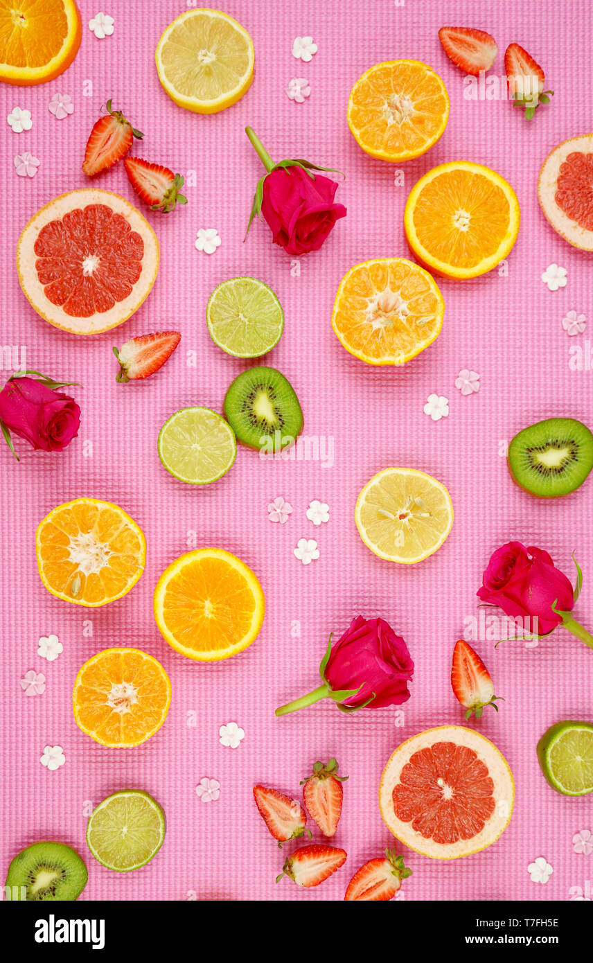 Summertime theme background with fruit, citrus and flowers on pink ...